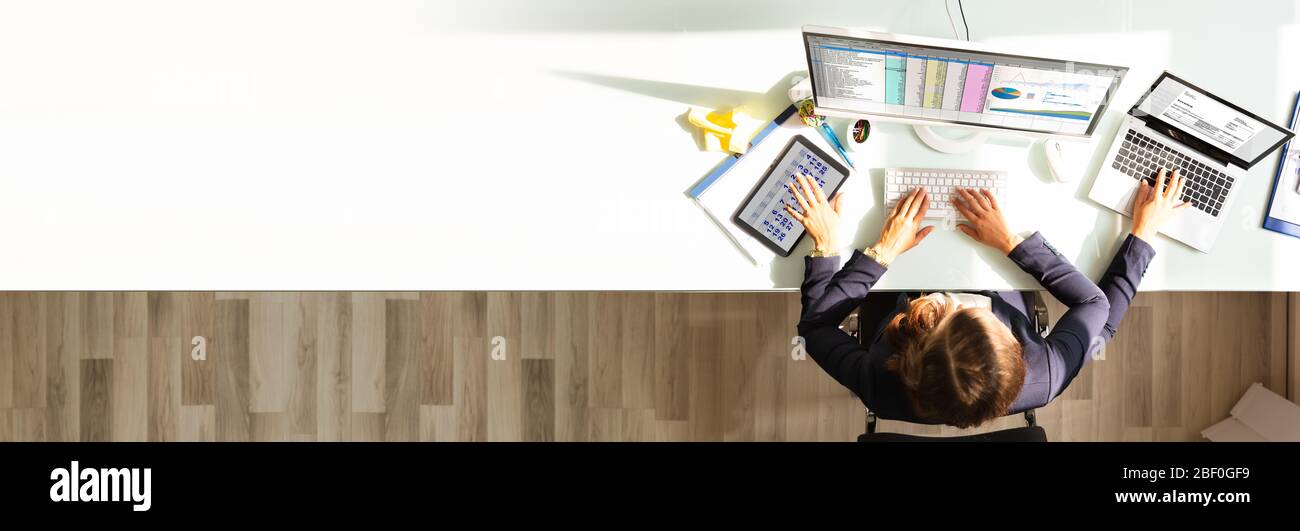 Multitasking Woman Working On Computer In Office Stock Photo - Alamy