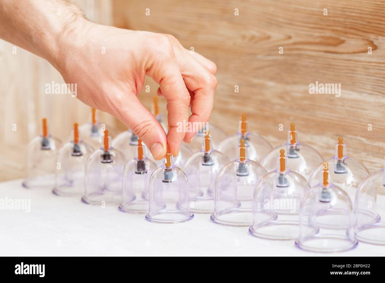 Hand taking vacuum massage glass jar from medical set of traditional ...