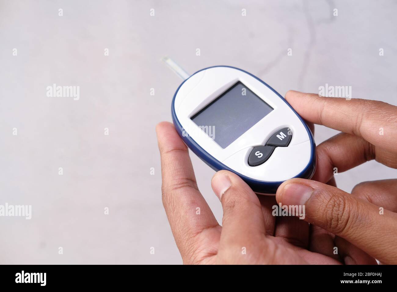 hand holding diabetic measurement kit isolated on white Stock Photo - Alamy