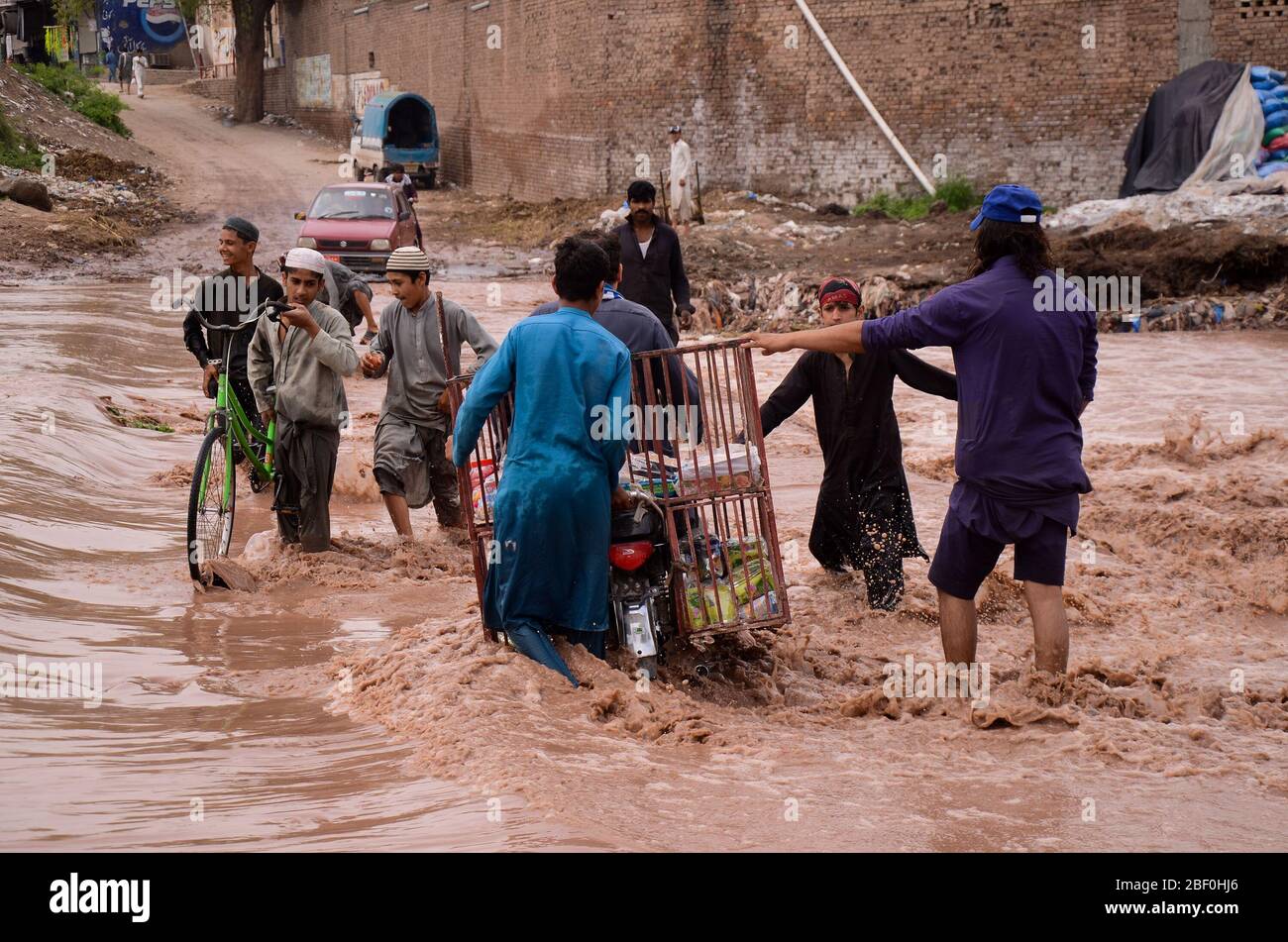 April 16, 2020: Peshawar, Pakistan. 16 April 2020. Locals wade through ...