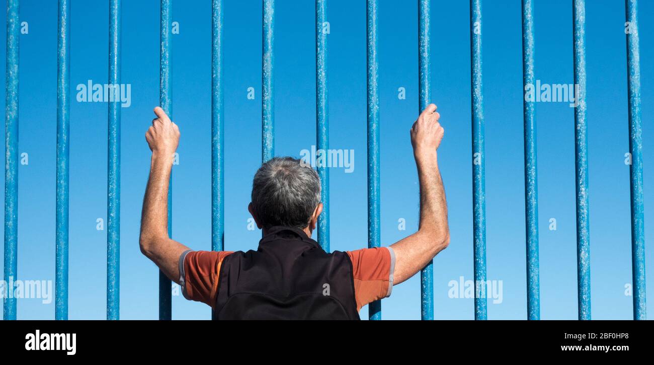 Man looking through prison bars hi-res stock photography and images - Alamy