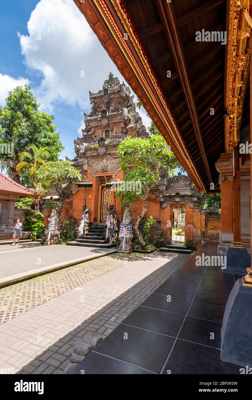 Vertical view of tourists at the main gates of Ubud palace in Bali ...