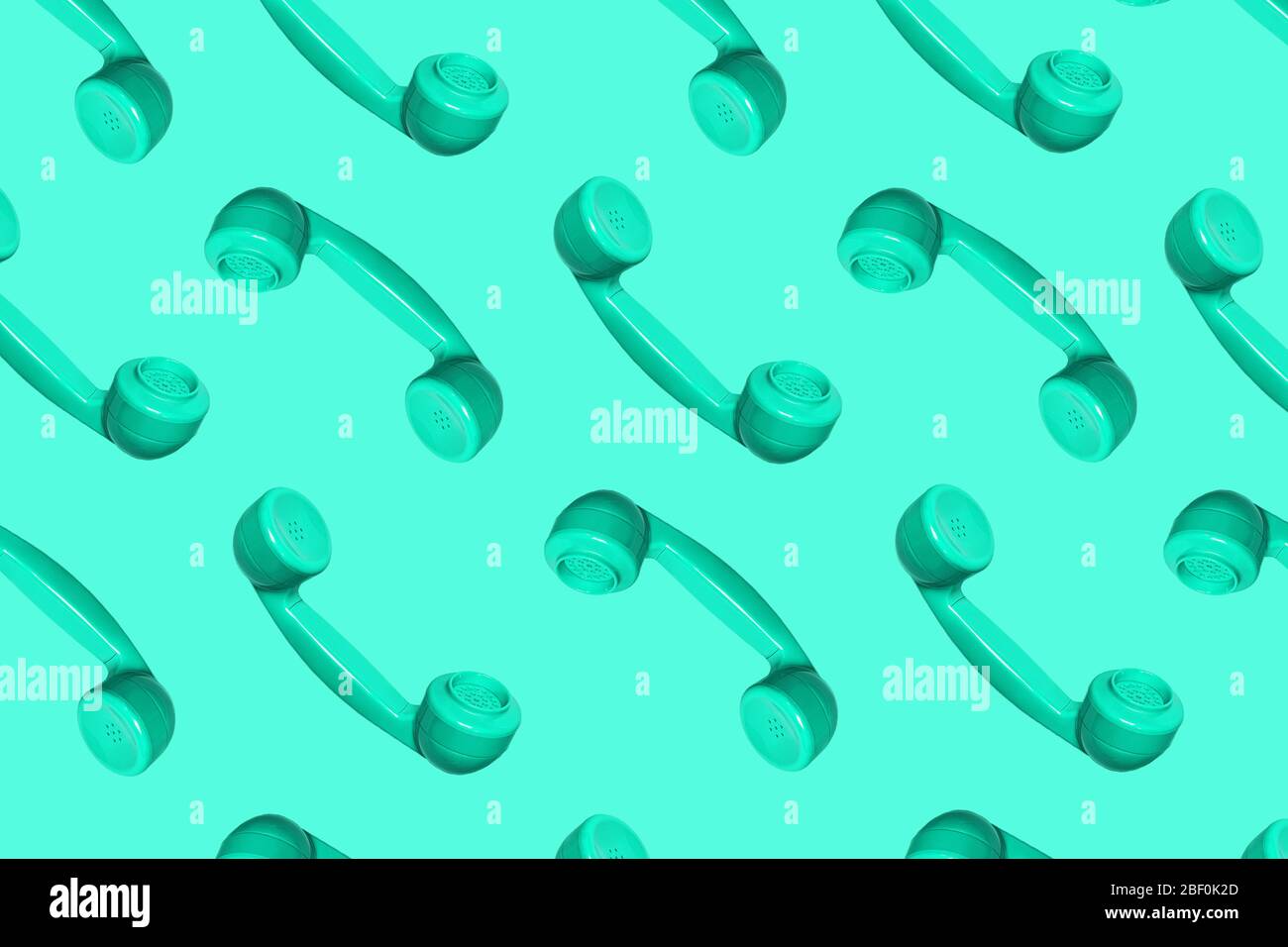 Pattern made from neo mint colored handset of a telephone on green mint ...