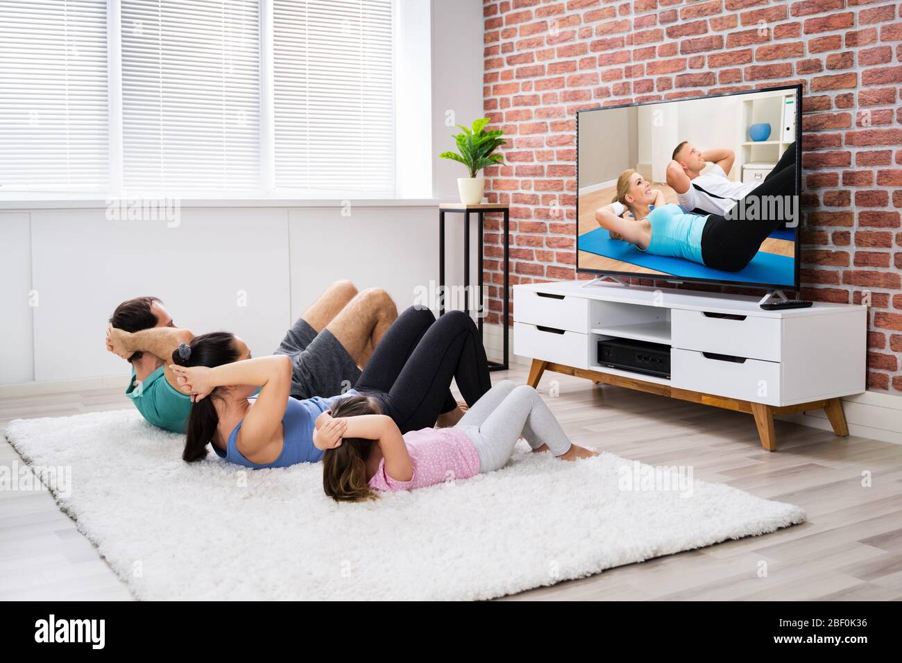 Fit Family Doing Home Online Fitness Exercise Stock Photo - Alamy