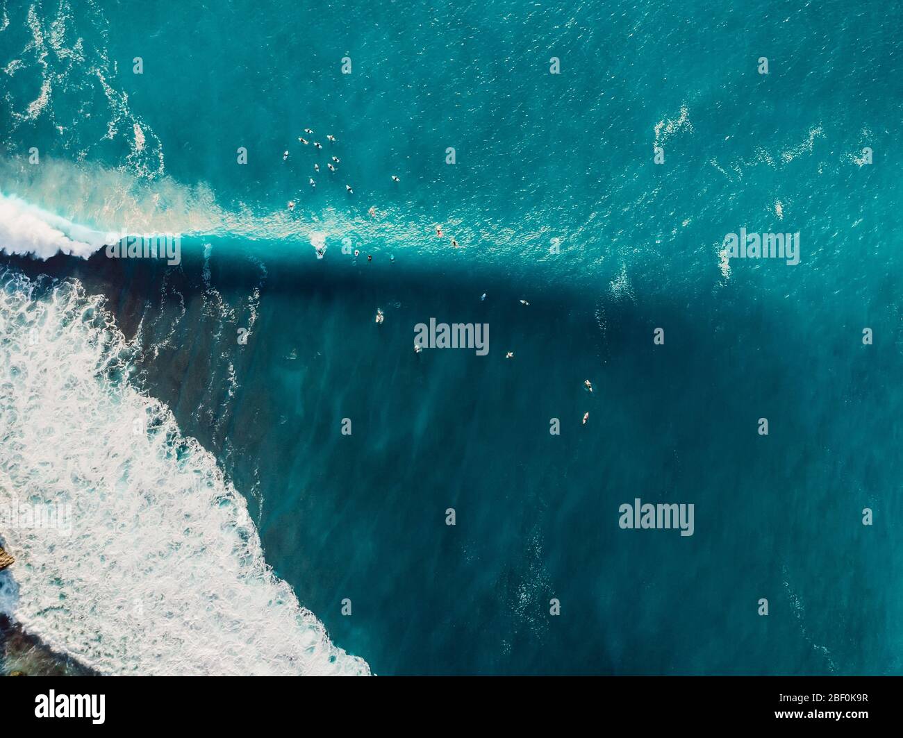 Aerial view with surfers and wave in crystal blue ocean. Top view Stock ...