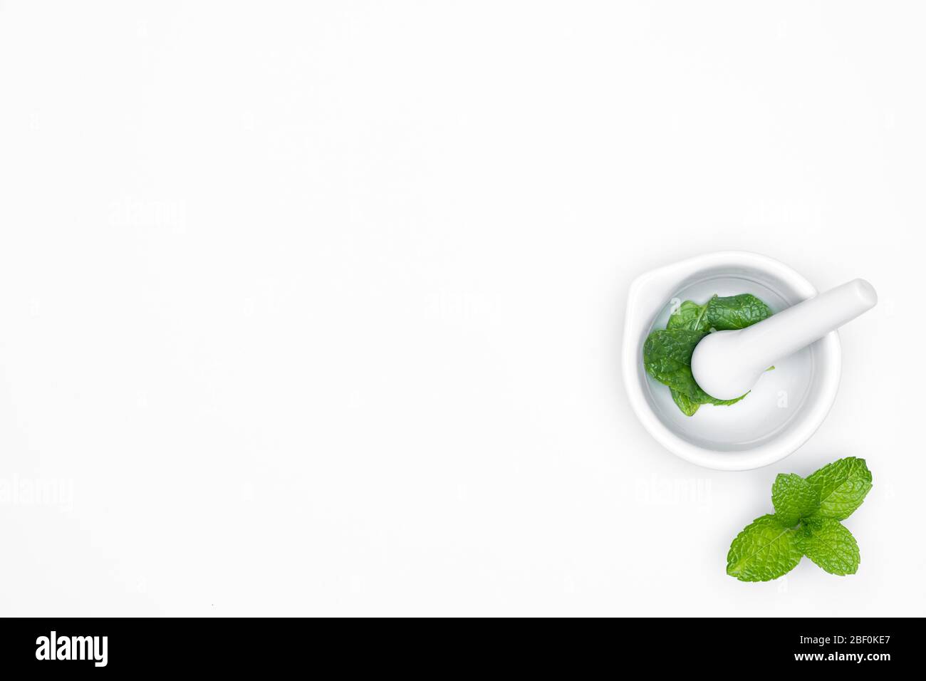 Mortar Grinder drugs with fresh herbs - Mints isolated on white ...