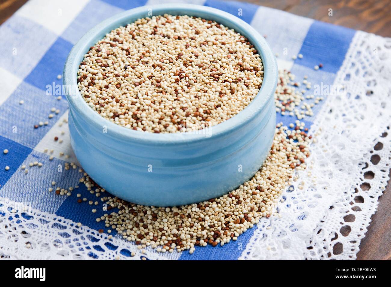 Organic quinoa grains in blue ceramic bowl, Gluten free. Concept ...