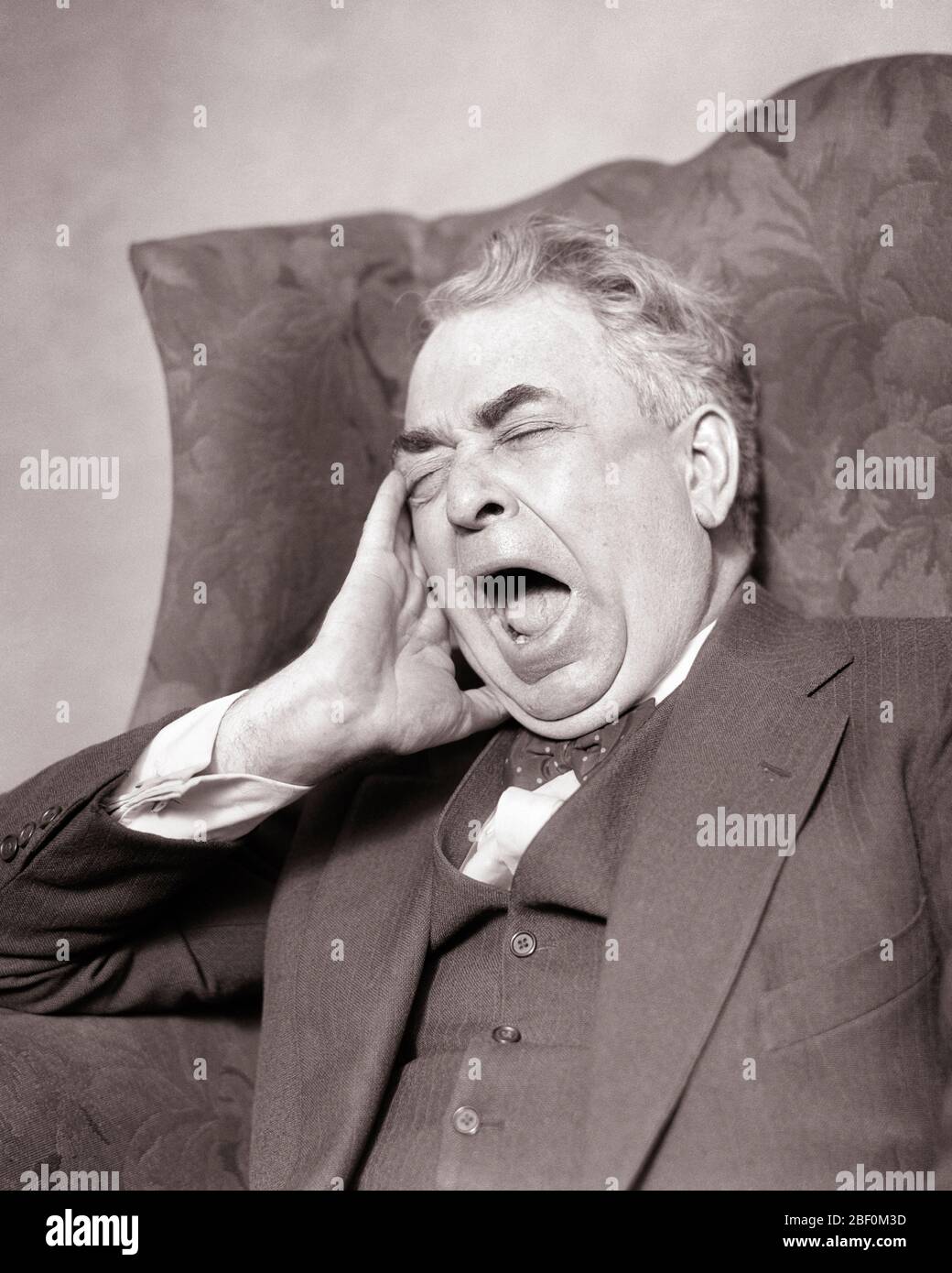1930s TIRED SLEEPY SENIOR MAN SITTING IN WING CHAIR YAWNING DOZING ...