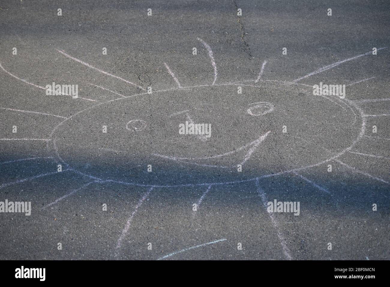 a Sun painted in Chalk on the Street Stock Photo - Alamy