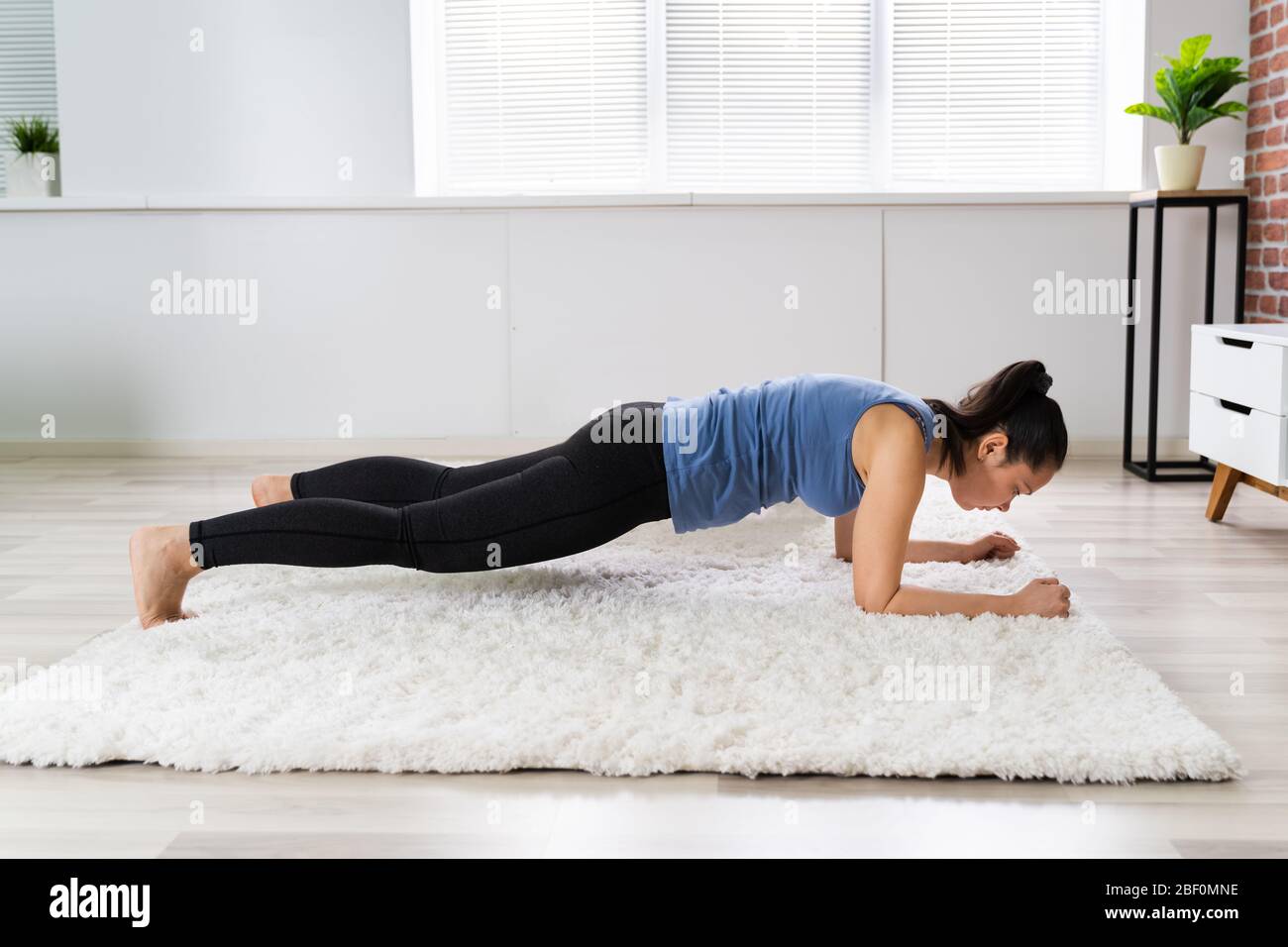 Young woman exercising plank hi-res stock photography and images - Alamy