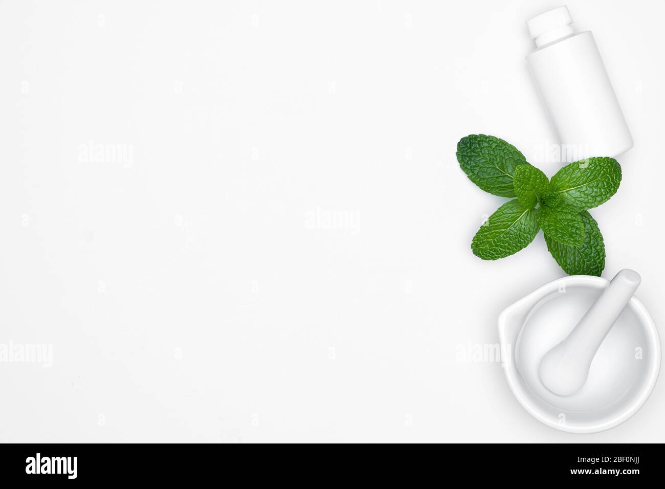 Mortar Grinder drugs and bottle with fresh herbs - Mints isolated on ...