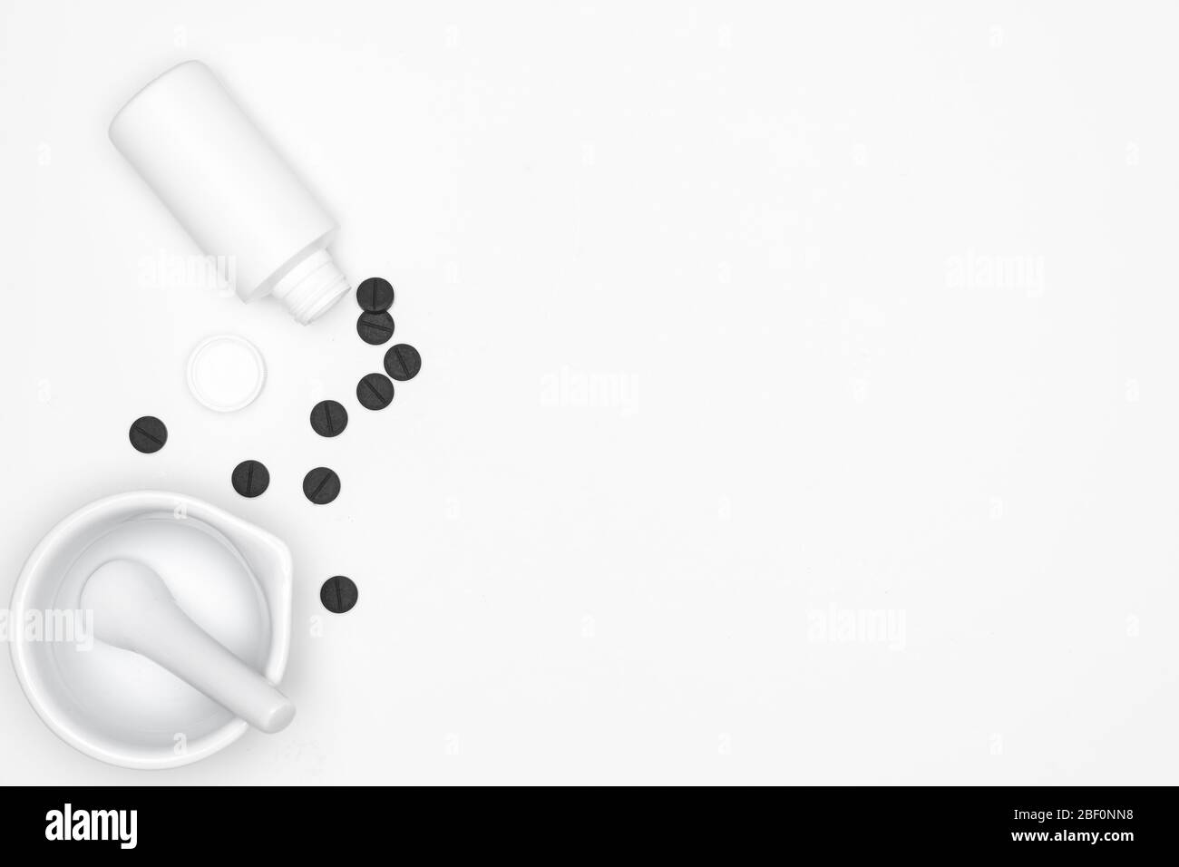 A white bottle and mortar grinder drugs with medicine - pills or ...