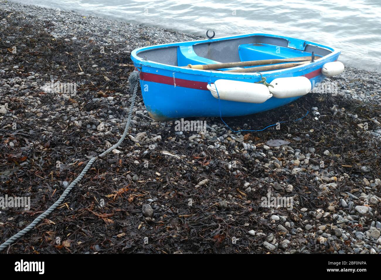 Pebble beach with a boat hi-res stock photography and images - Alamy