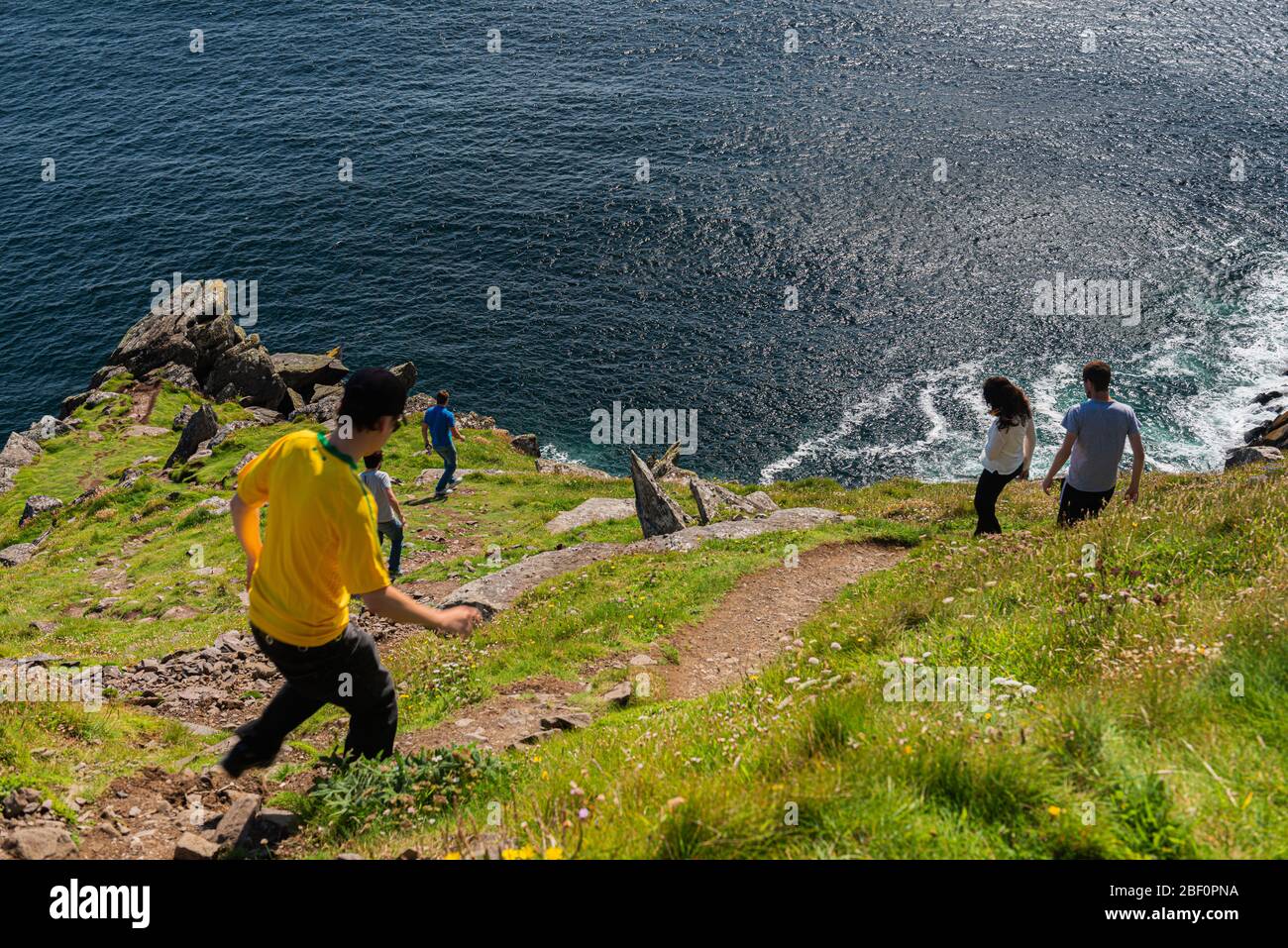 Group of young people enjoying the breathtaking view of the sea while ...