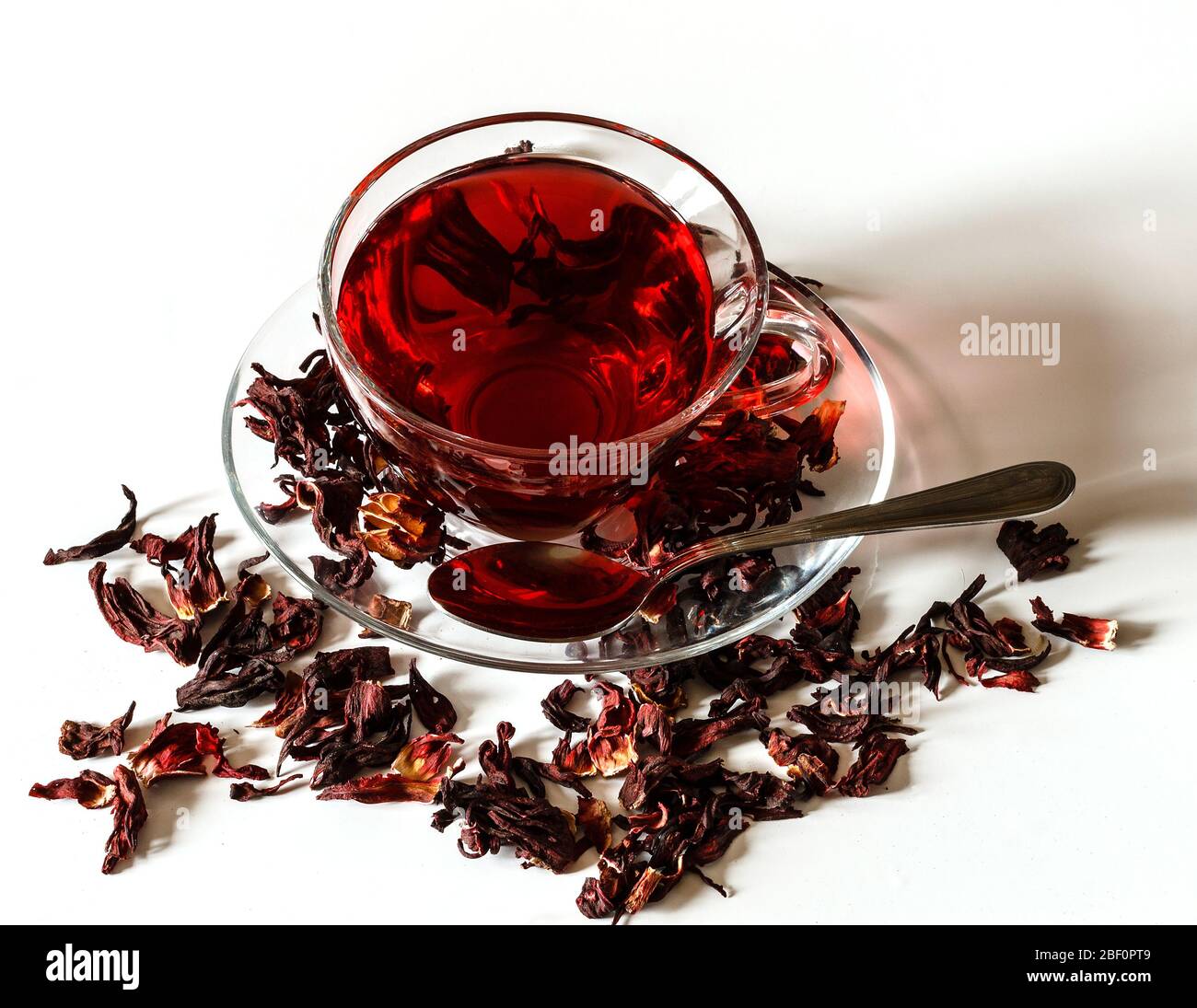 Cup of Karkadeh Red Tea with Dry Flowers isolated on a white background ...