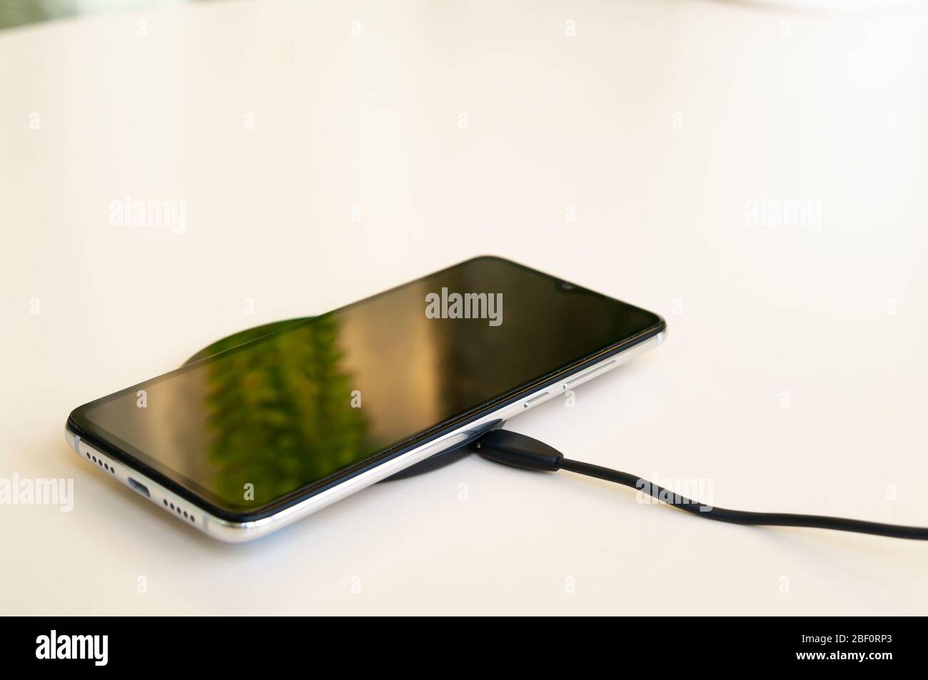 Smartphone wireless charging on induction charger. Wireless charger ...