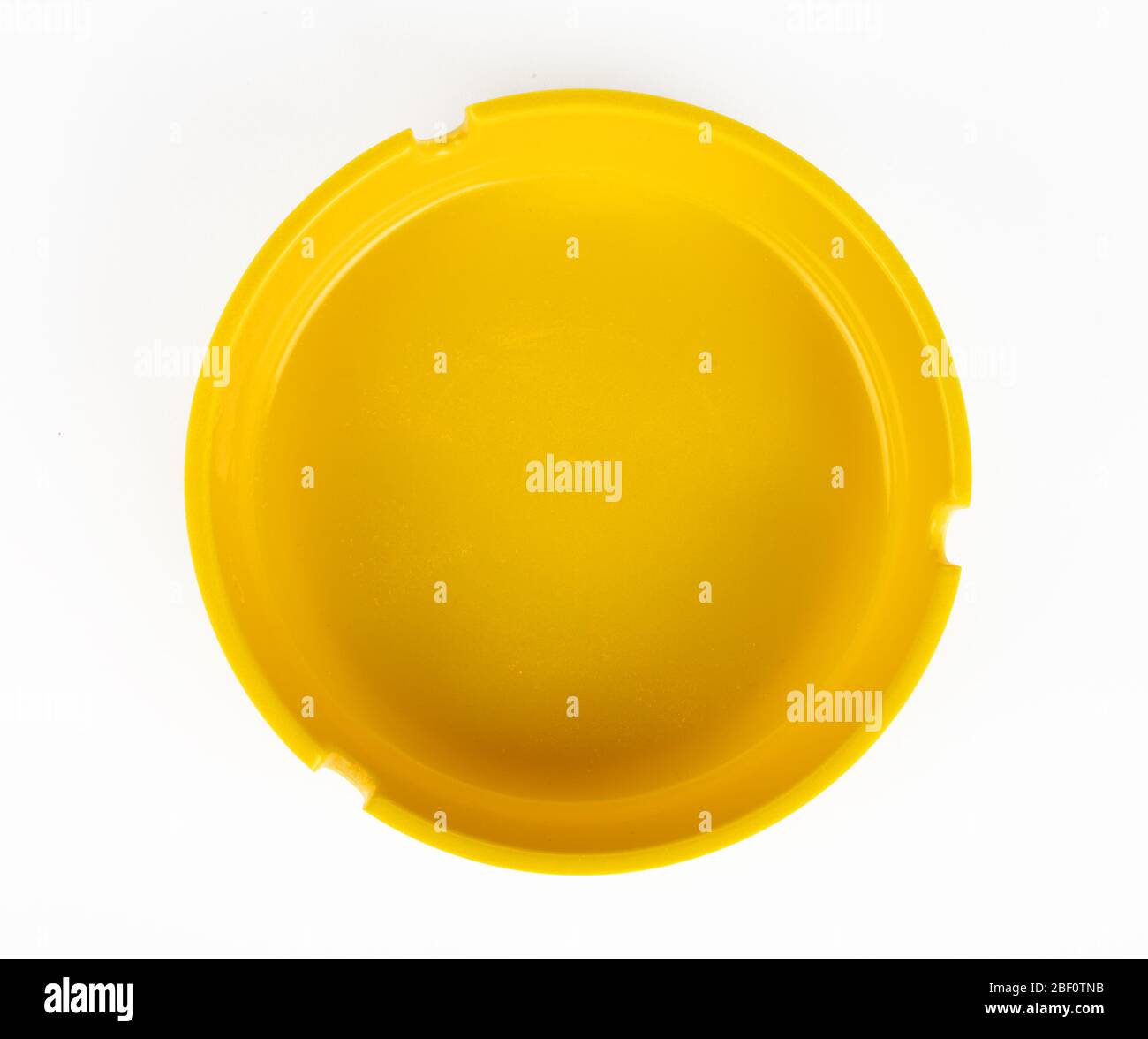 Yellow round ashtray on a white background isolate Stock Photo - Alamy