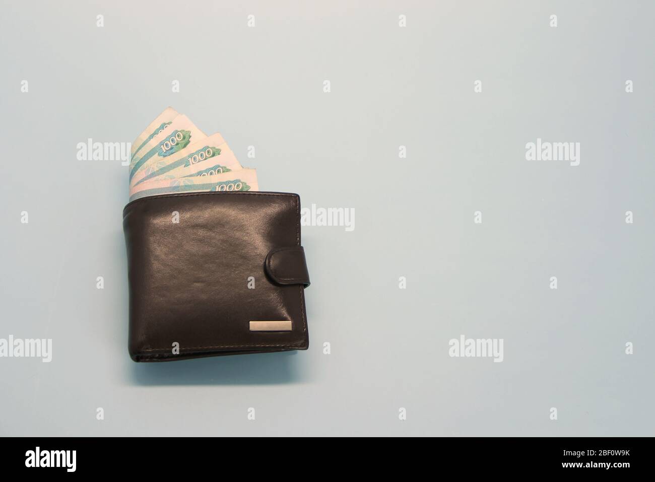 Leather brown wallet with Russian money sticking out of it in banknotes ...