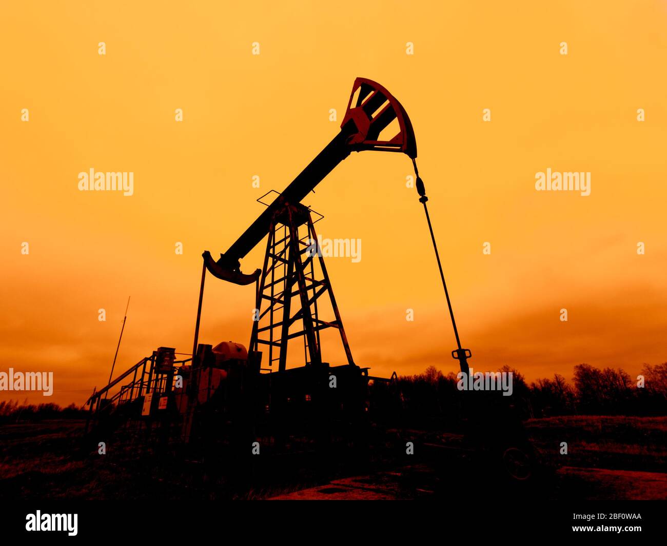 Oil pump oil rig energy industrial machine for petroleum in the sunset ...