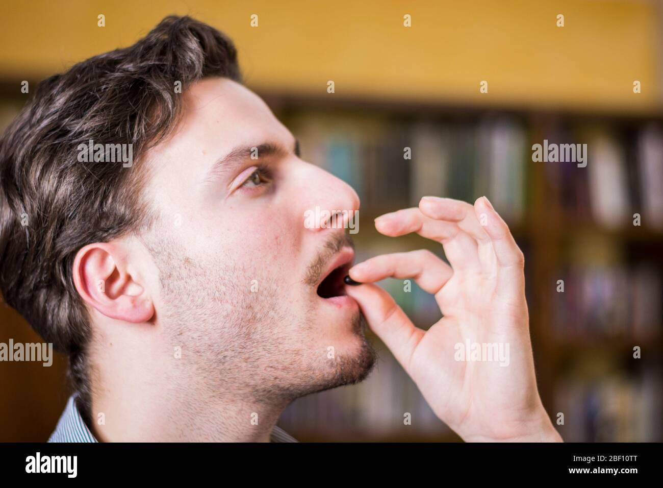 Male eating medicine pill hi-res stock photography and images - Alamy