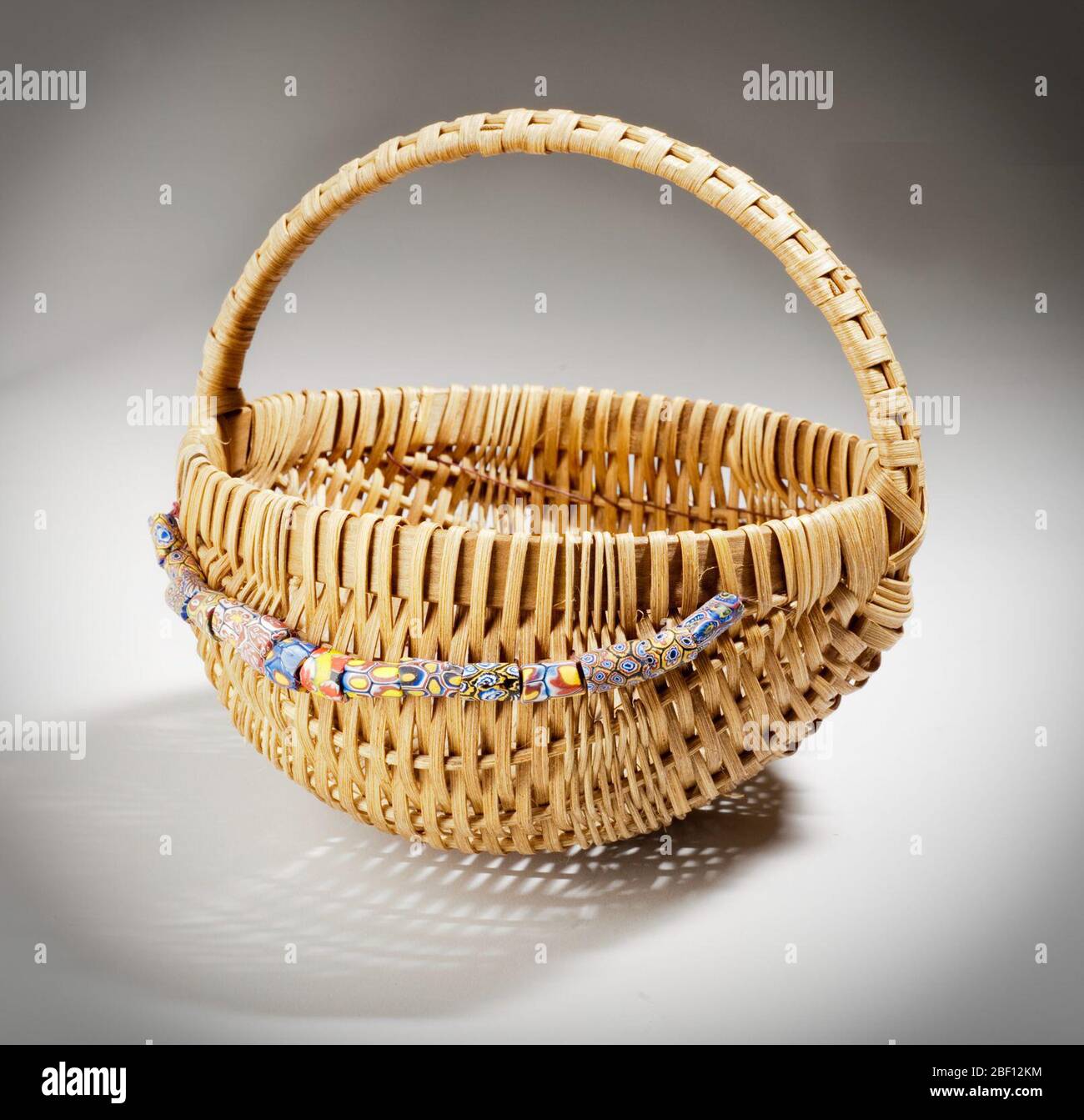 Handmade Basket with Handle and String of Beads Stock Photo - Alamy