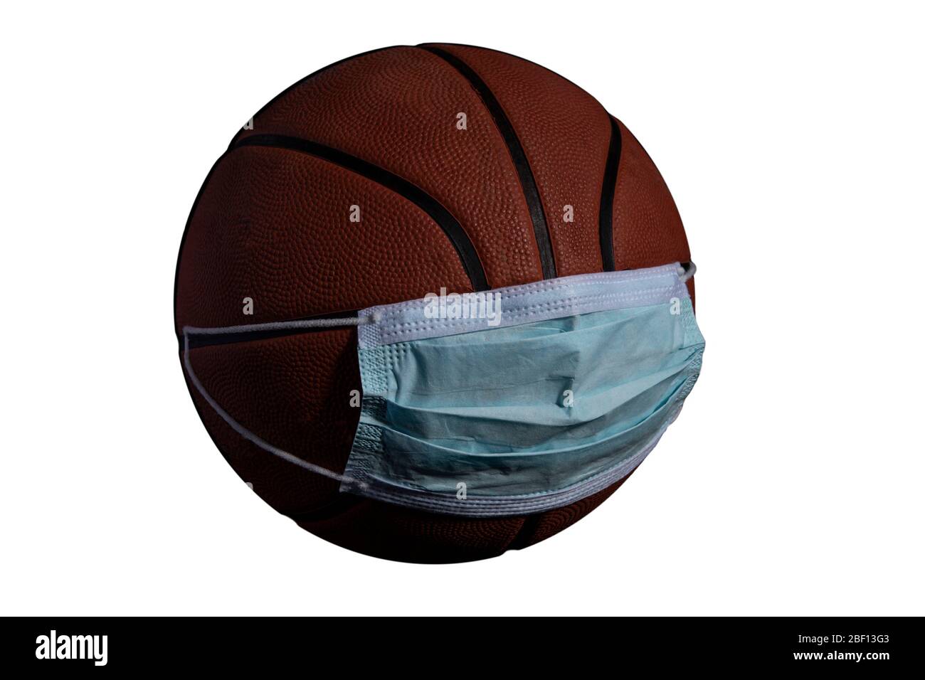 Basketball ball wearing a mask, concept of sports suffering from the ...