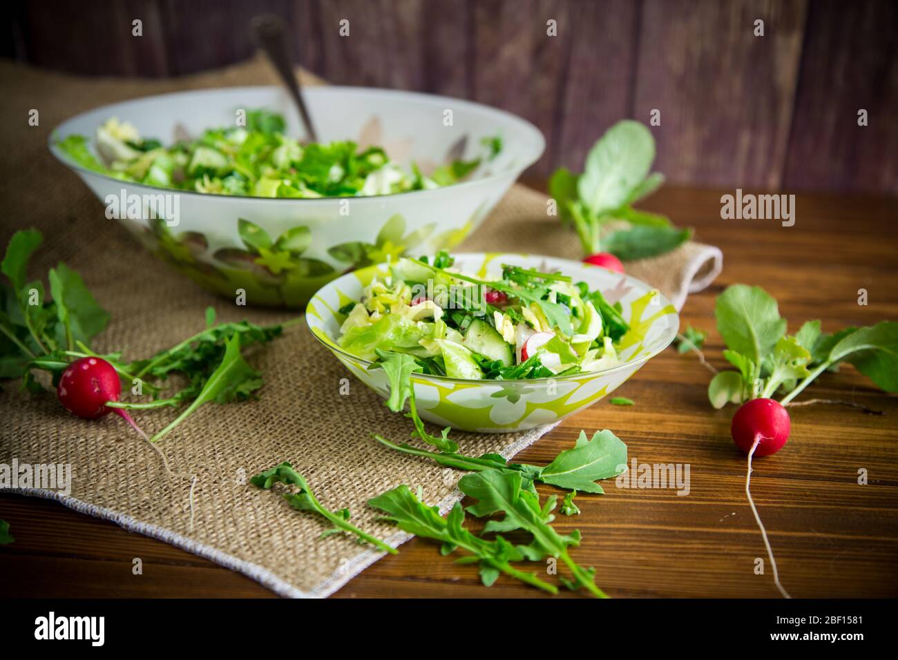 Spring salad from early vegetables, lettuce leaves, radishes and herbs ...