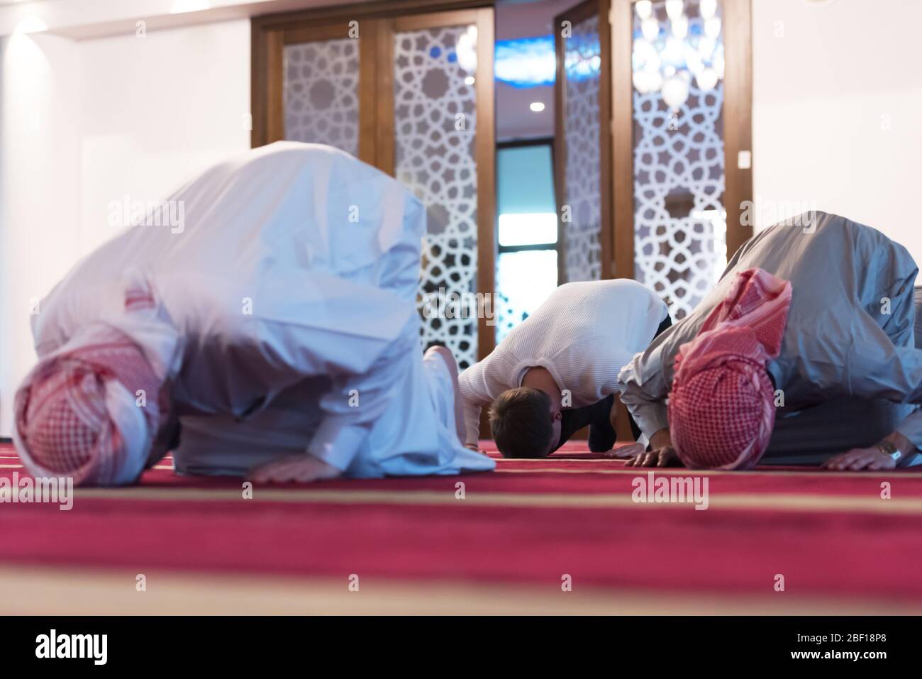 Group of young Muslim people praying. Muslim prayers doing a pray ...