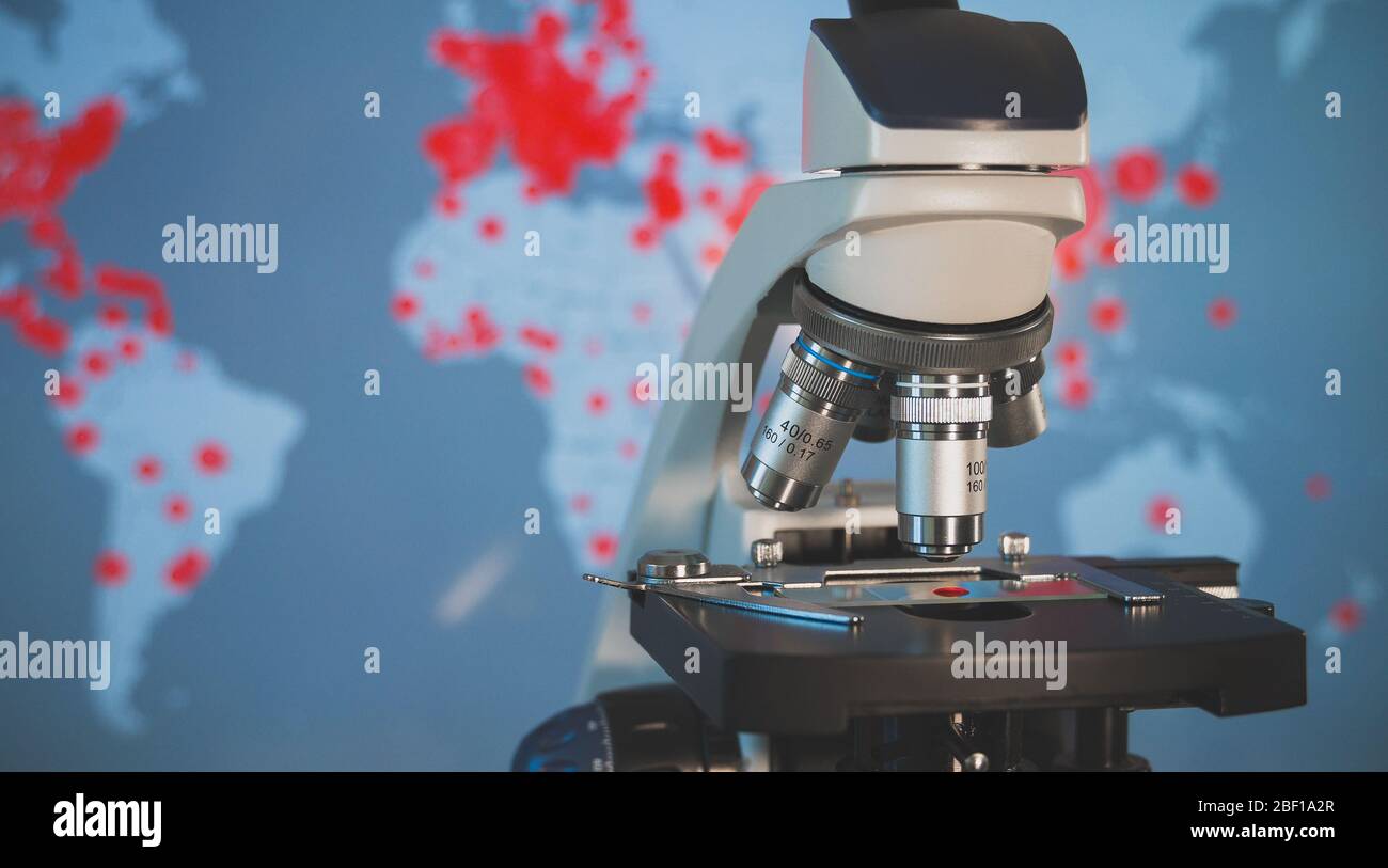 Laboratory microscope with blood sample. Coronavirus map infection on ...