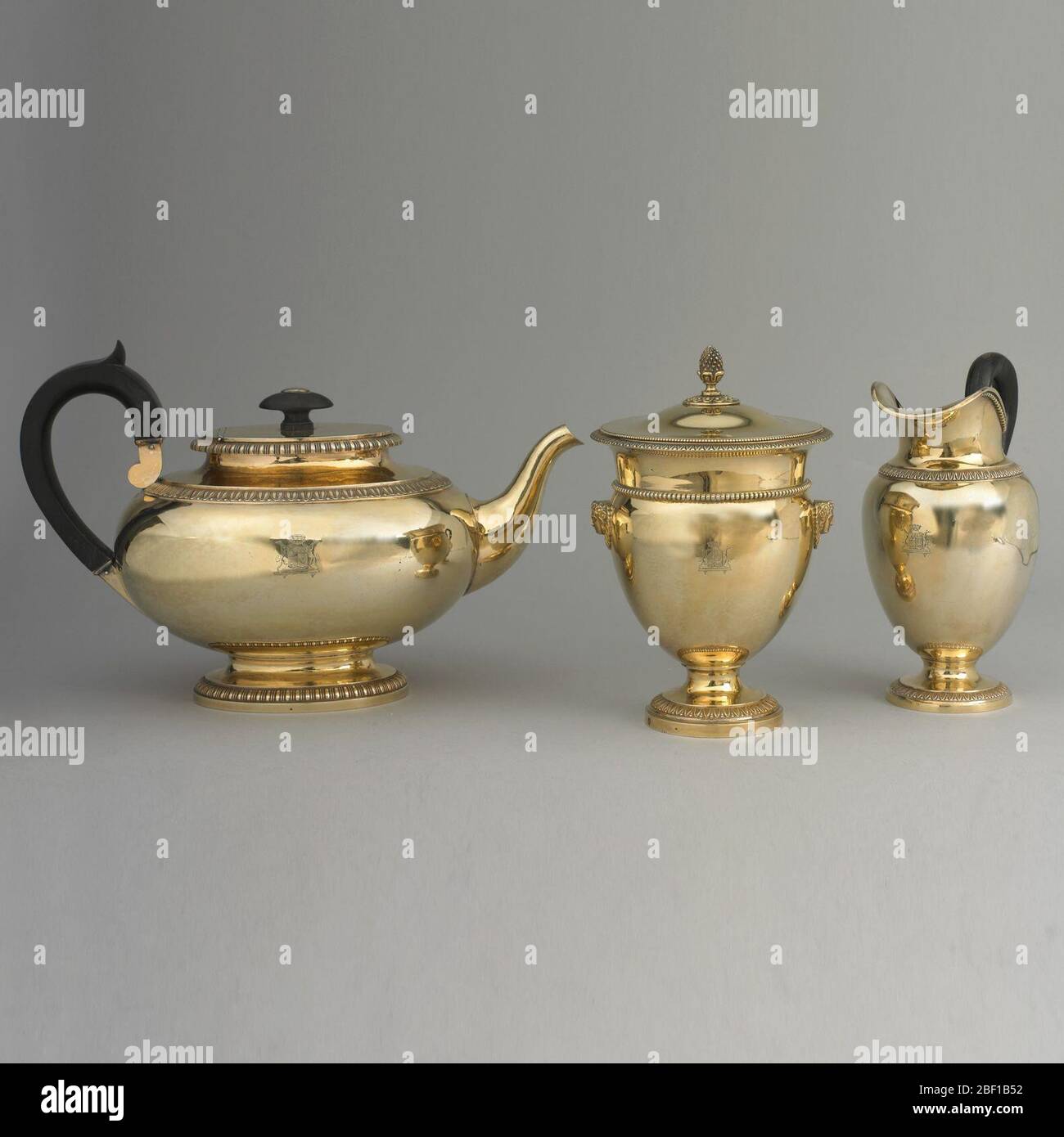Teapot. Bulbous low footed gilt teapot with long spout. Bands of ...