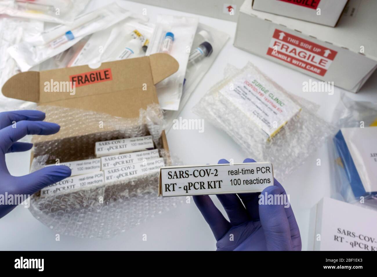 Nurse unpacking box with Covid-19 PCR kit in hospital warehouse ...