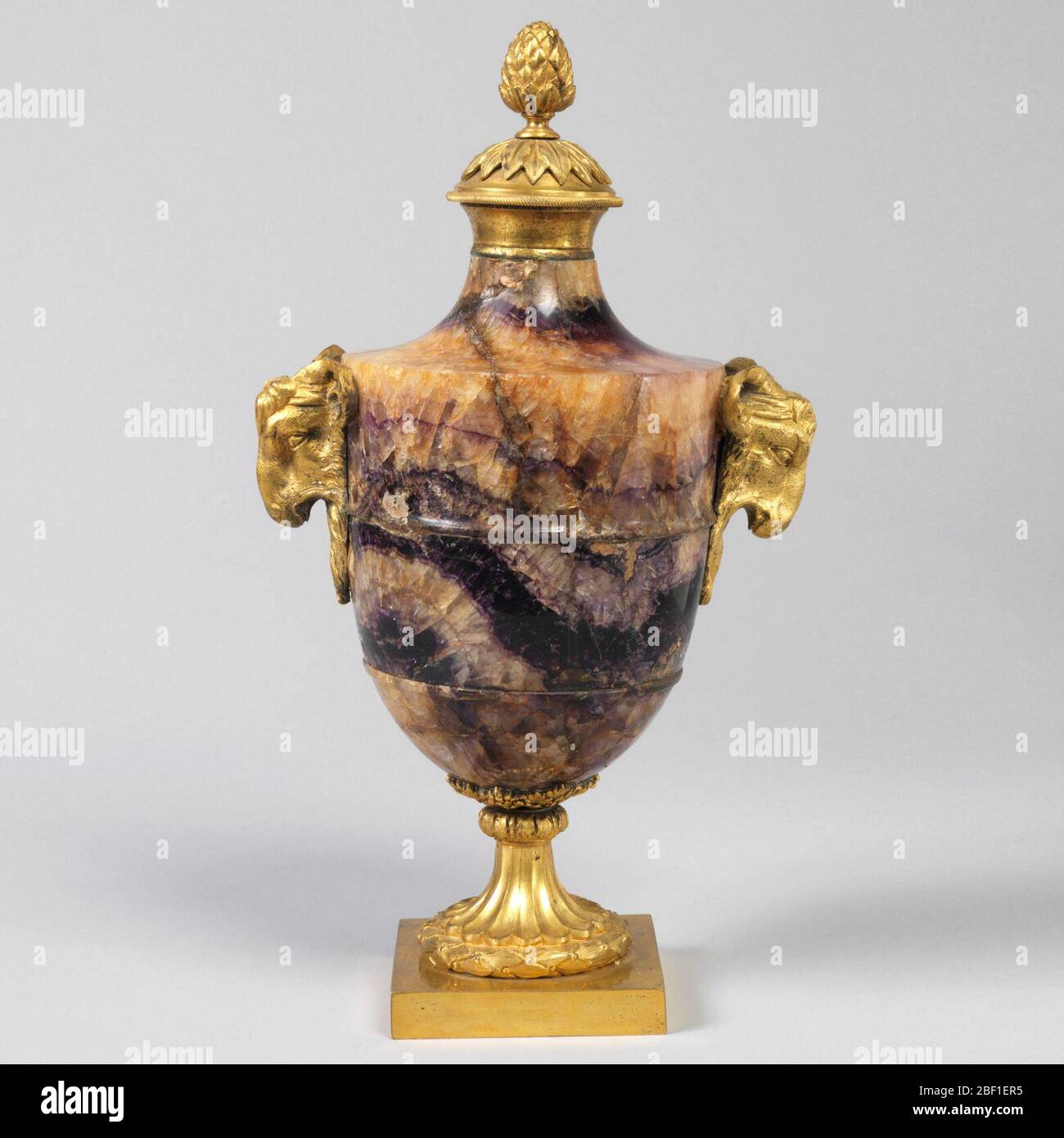 Urn. Amphora-shaped body of solid spar supported on fluted pedestal on ...