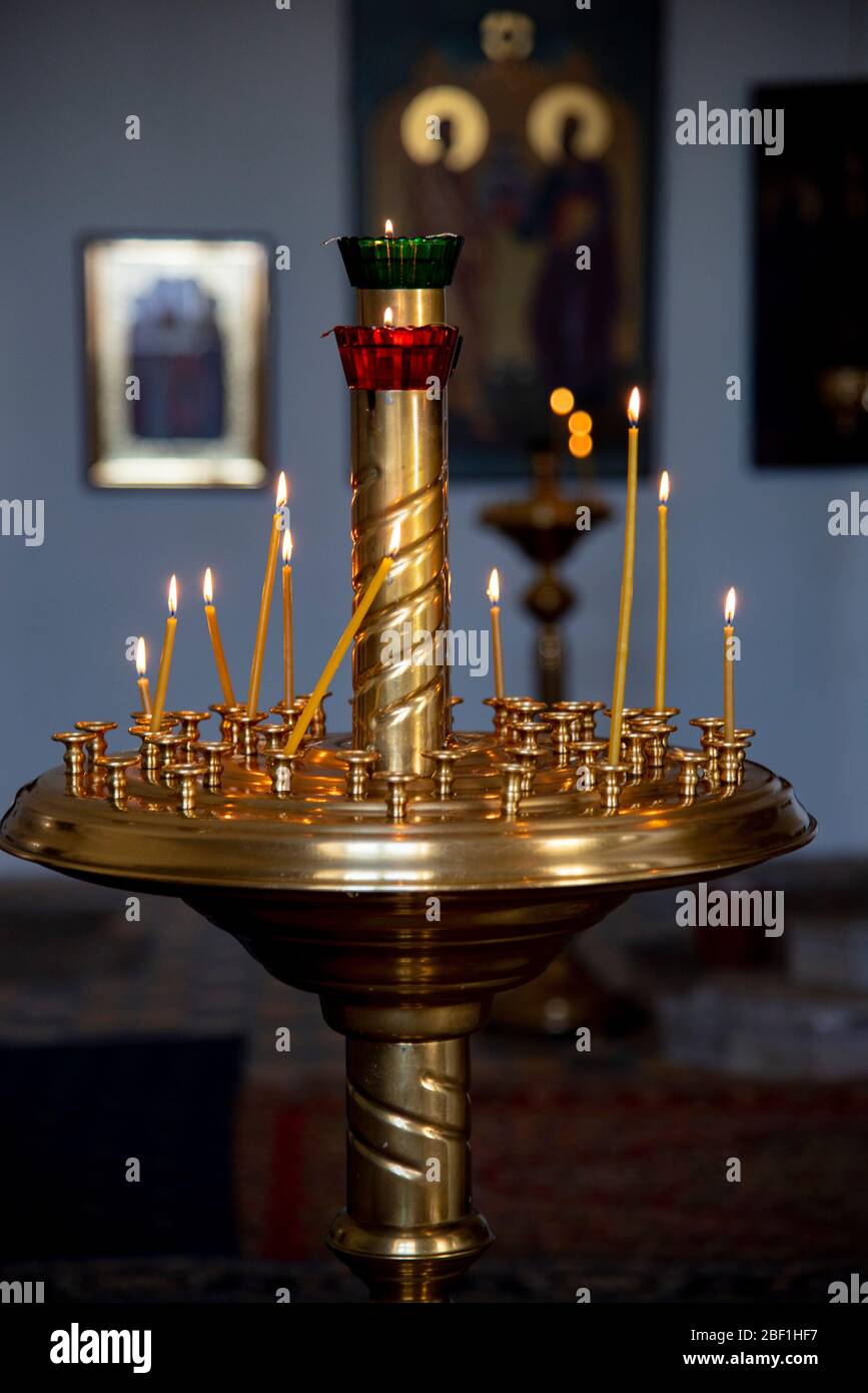 Large church golden candlestick with burning candles Stock Photo - Alamy