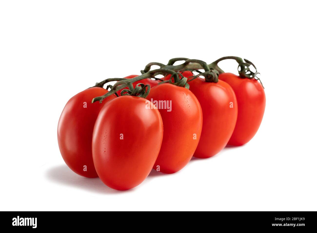 Oblong fresh red tomatoes isolated on a white background with clipping ...