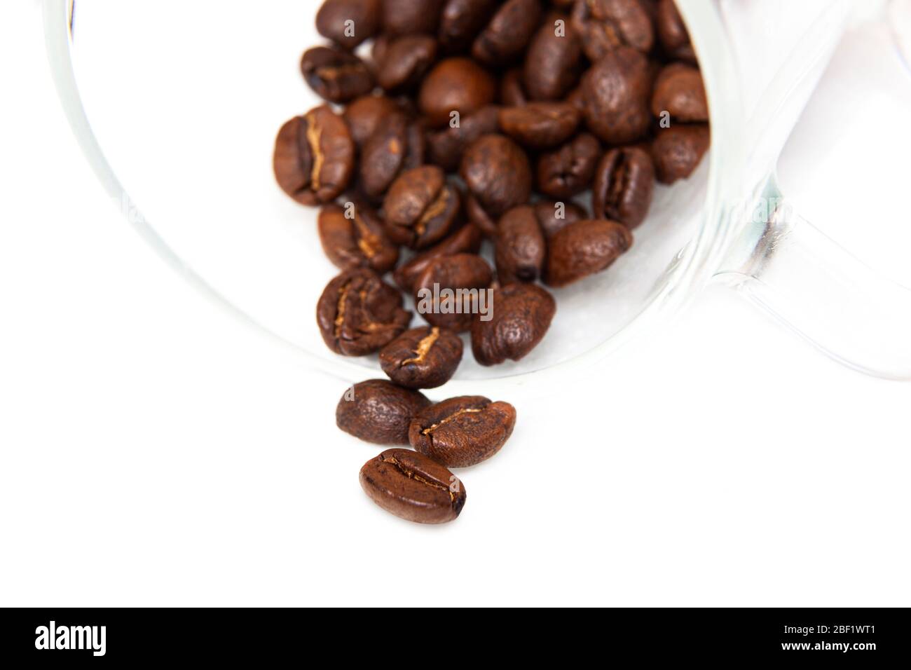 Macro capture of coffee beans in a glass cup on white background Stock ...