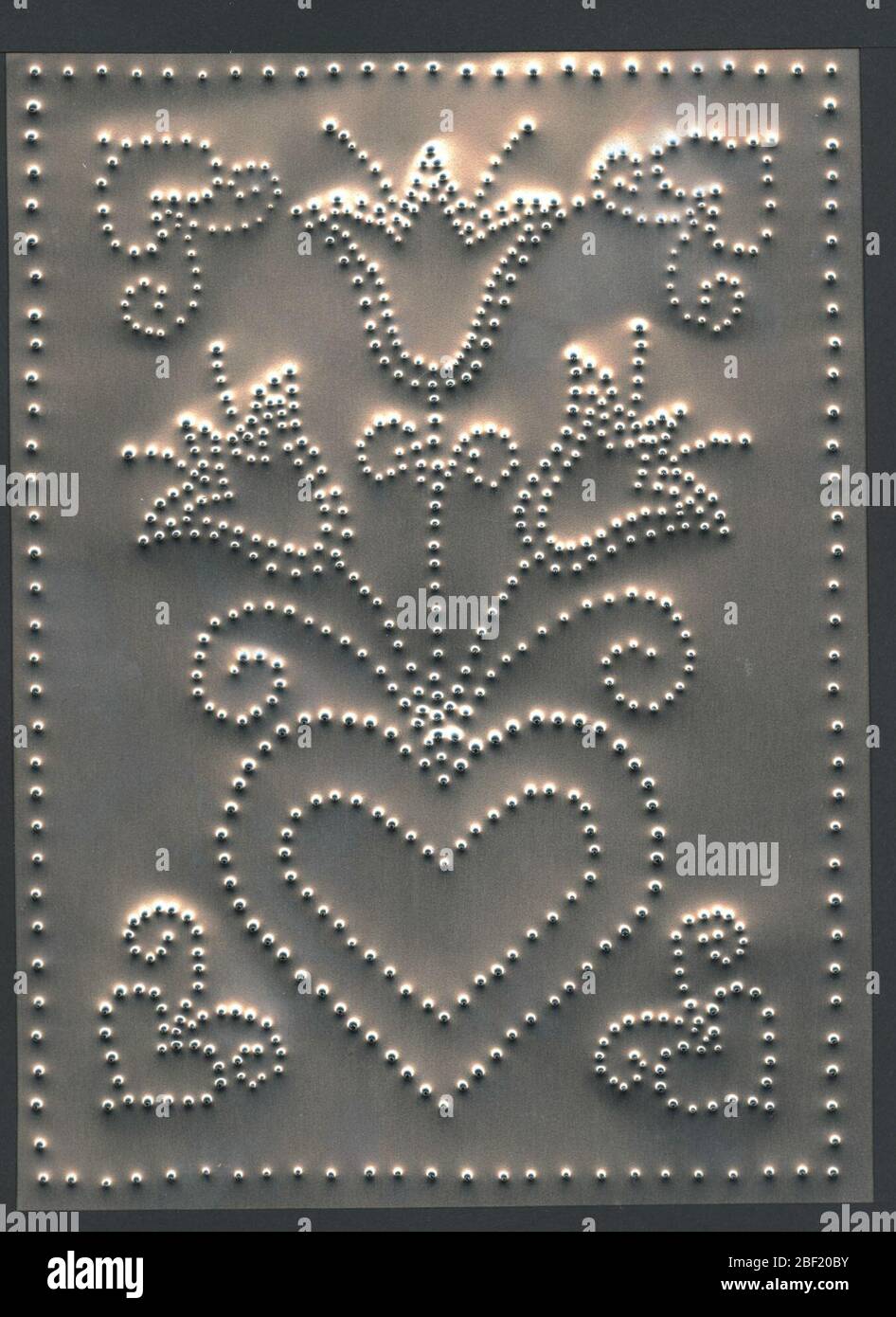 Tin Punch Design of Hearts and Flowers Stock Photo - Alamy
