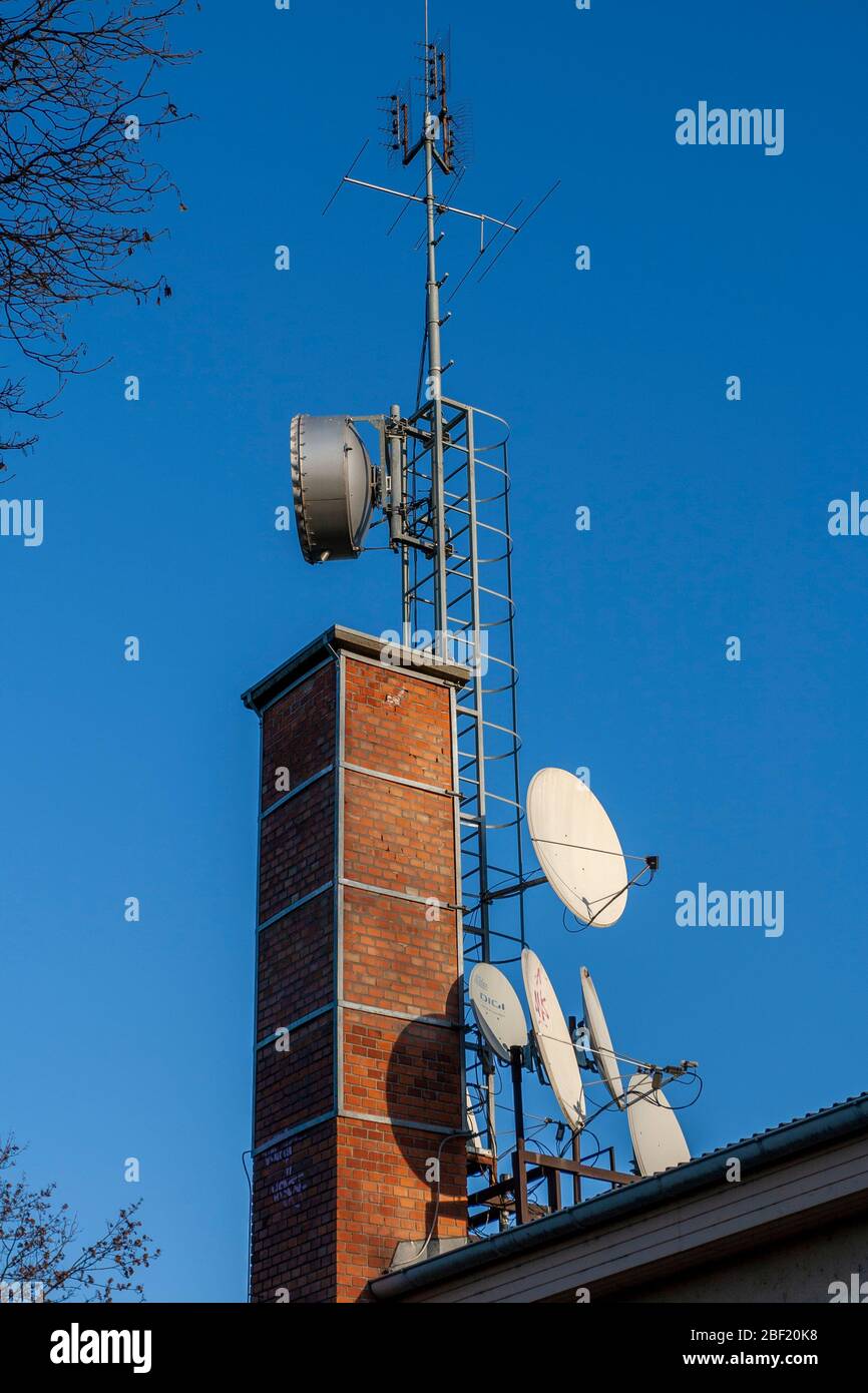 Telecommunication devices on a brick chimney Stock Photo - Alamy