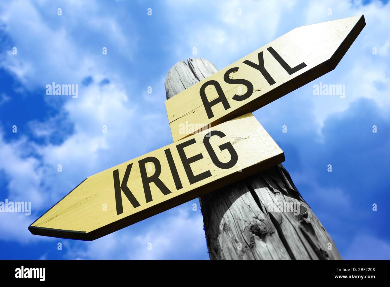 Asylum, war (German) - wooden signpost Stock Photo - Alamy