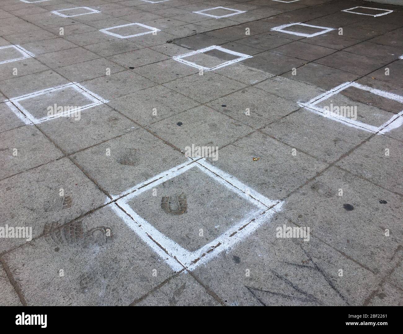 Social safe distancing measure. Marked spots of 1m on the floor of bank ...