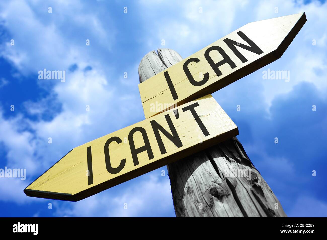 Can, can't - wooden signpost Stock Photo - Alamy
