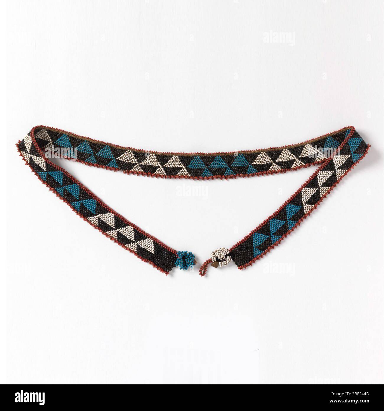 Belt. Long, narrow beaded belt with a design of opposing triangles in ...
