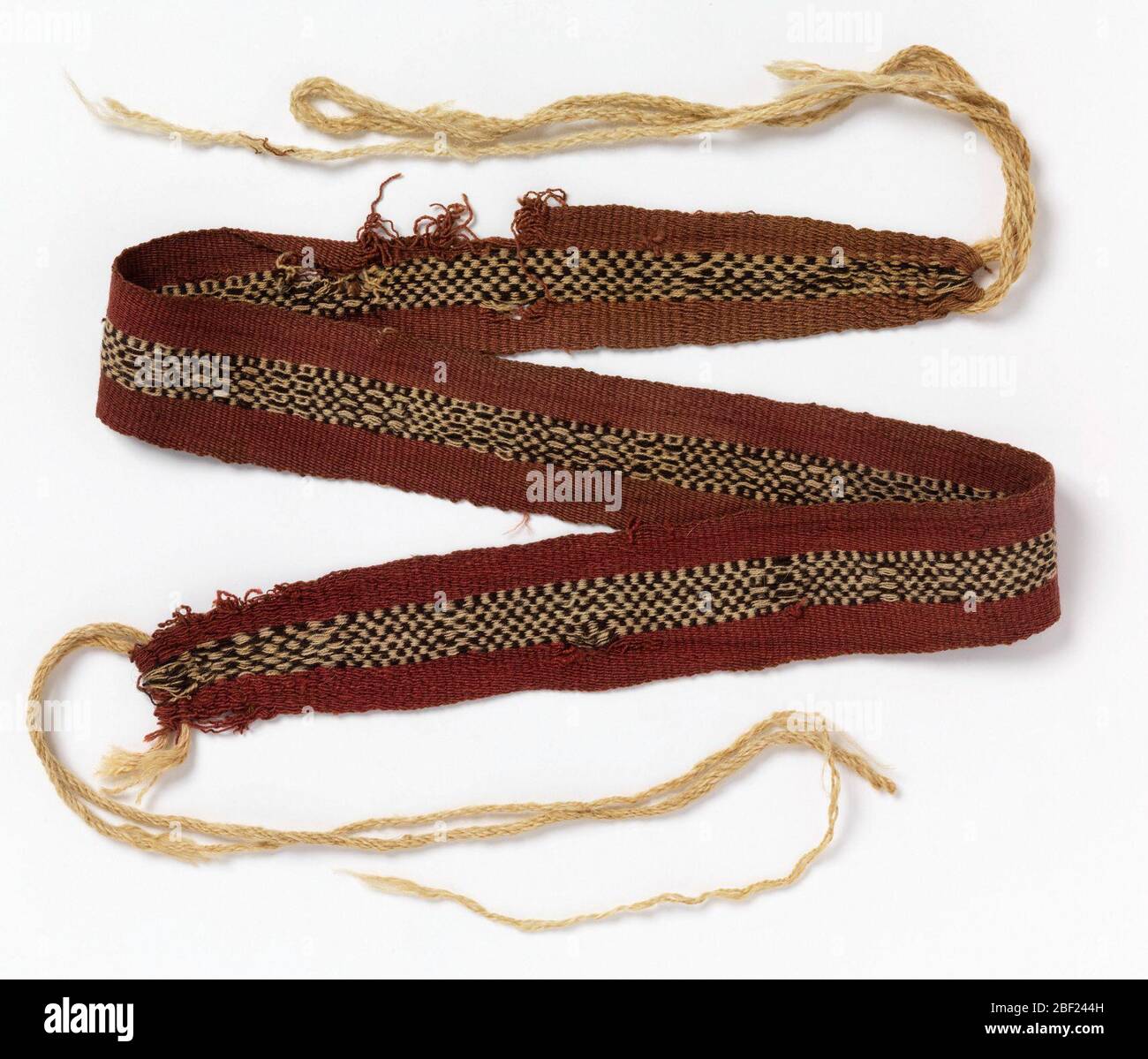 Band. Belt of dark red wool with center design of black and white ...