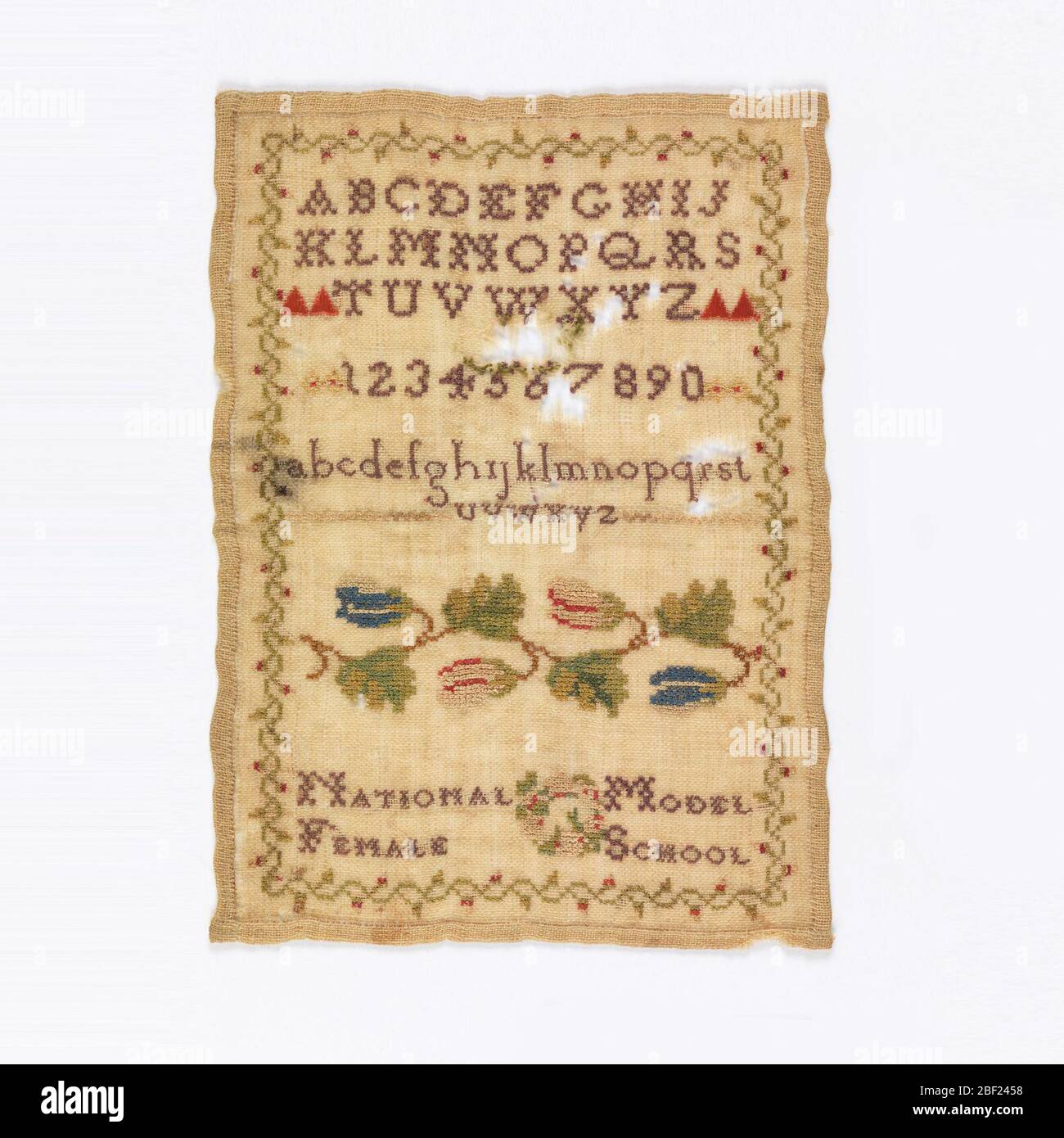 Sampler. Alphabets, numerals, floral cross border and text Stock Photo ...