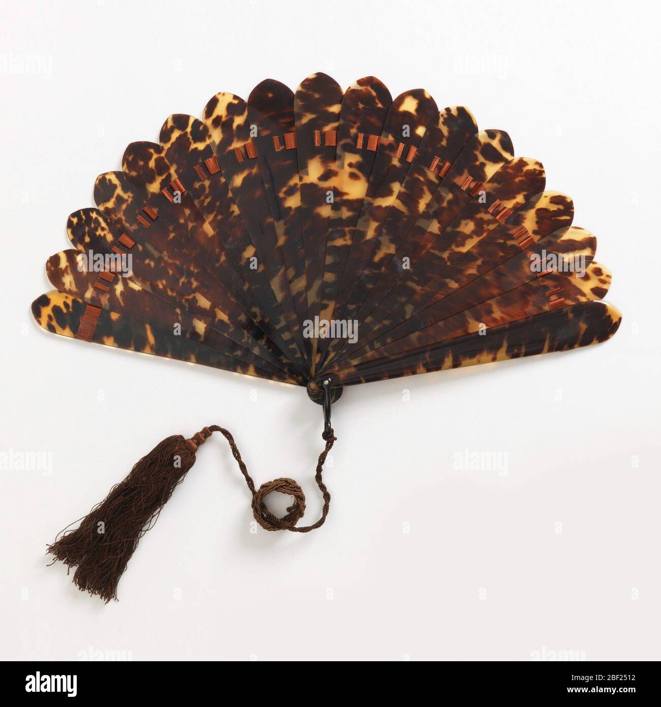 Bris fan. Brisé fan with tortoise shell sticks. Brown silk tassel ...