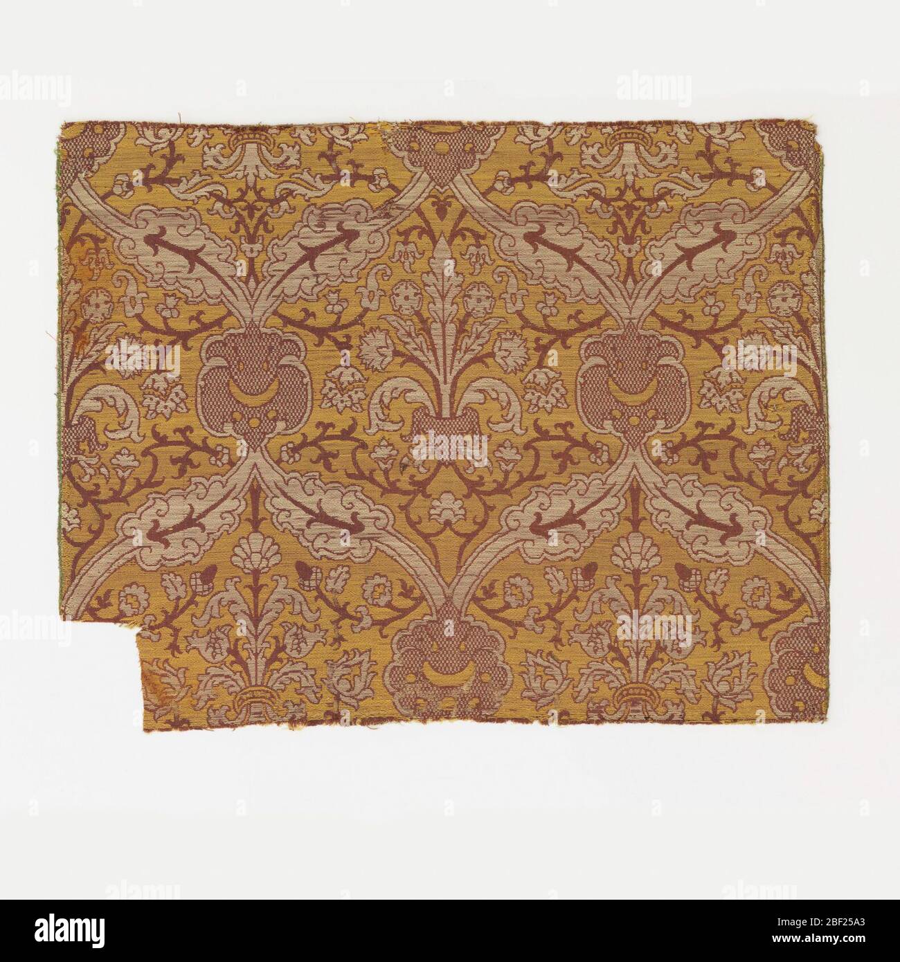 Fragment. Strapwork with checkerboard shield shapes and foliage in red ...