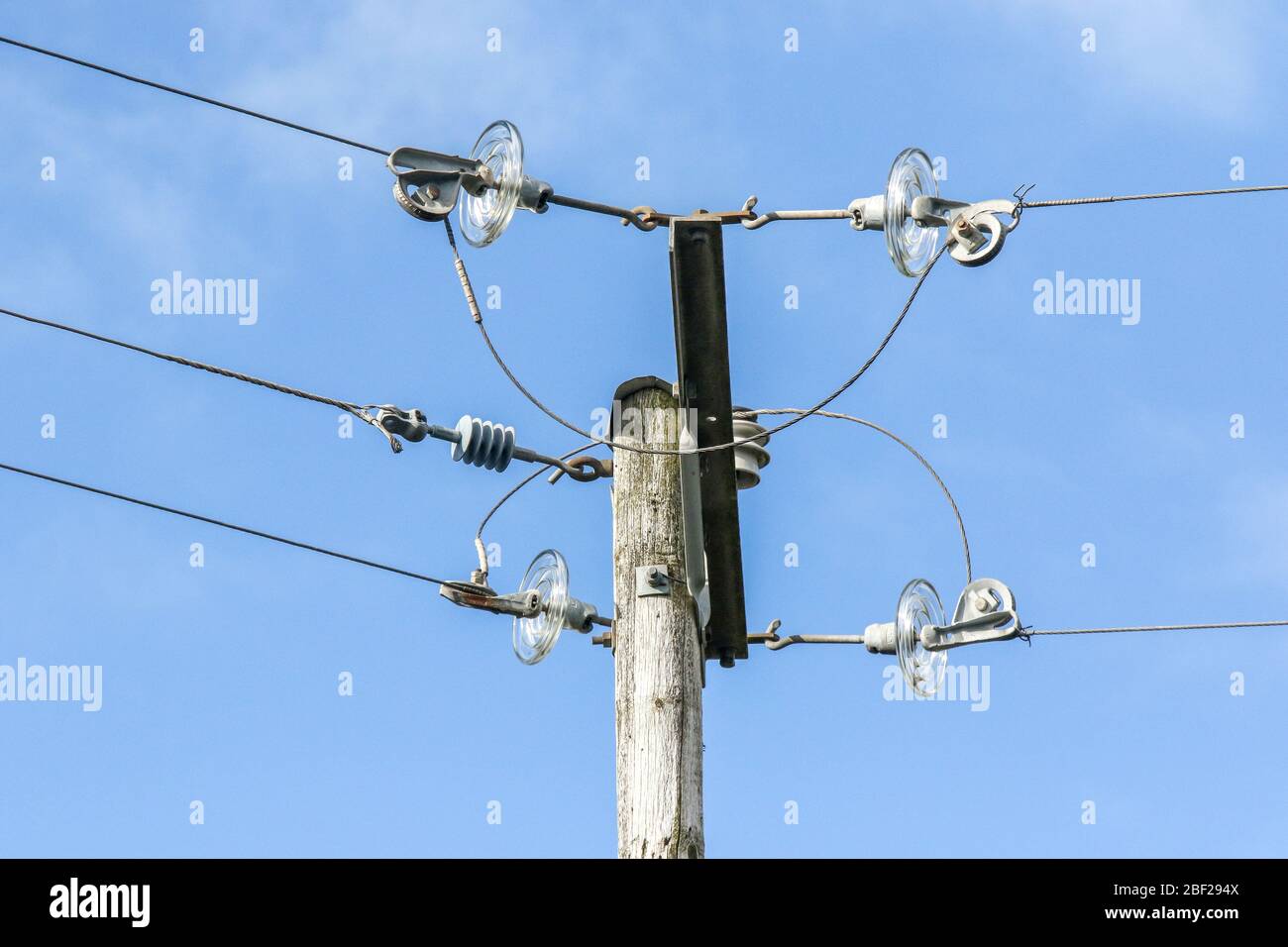 A wooden utility pole distributing electricity across a network in the ...