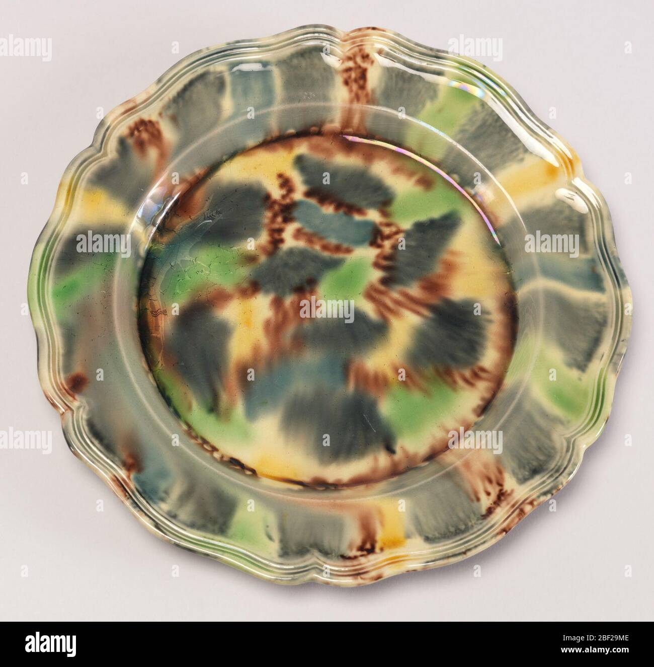 Plate. Polychrome "tortoise-shell" decoration in brown, with yellow ...