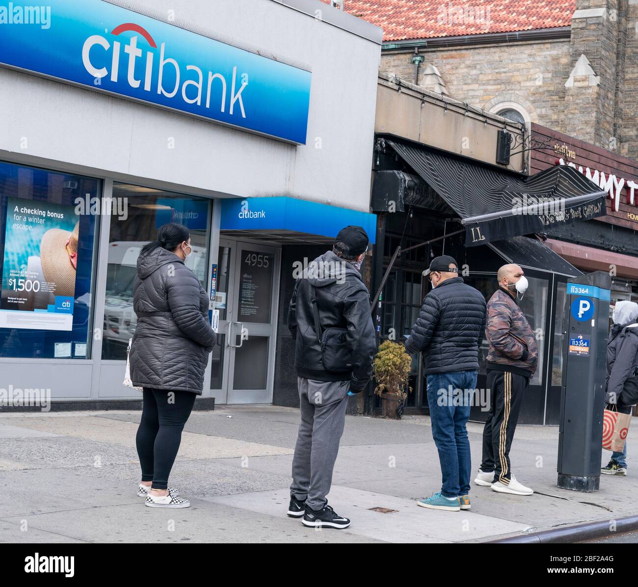 New York, NY - April 16, 2020: People waiting in line keeping social ...