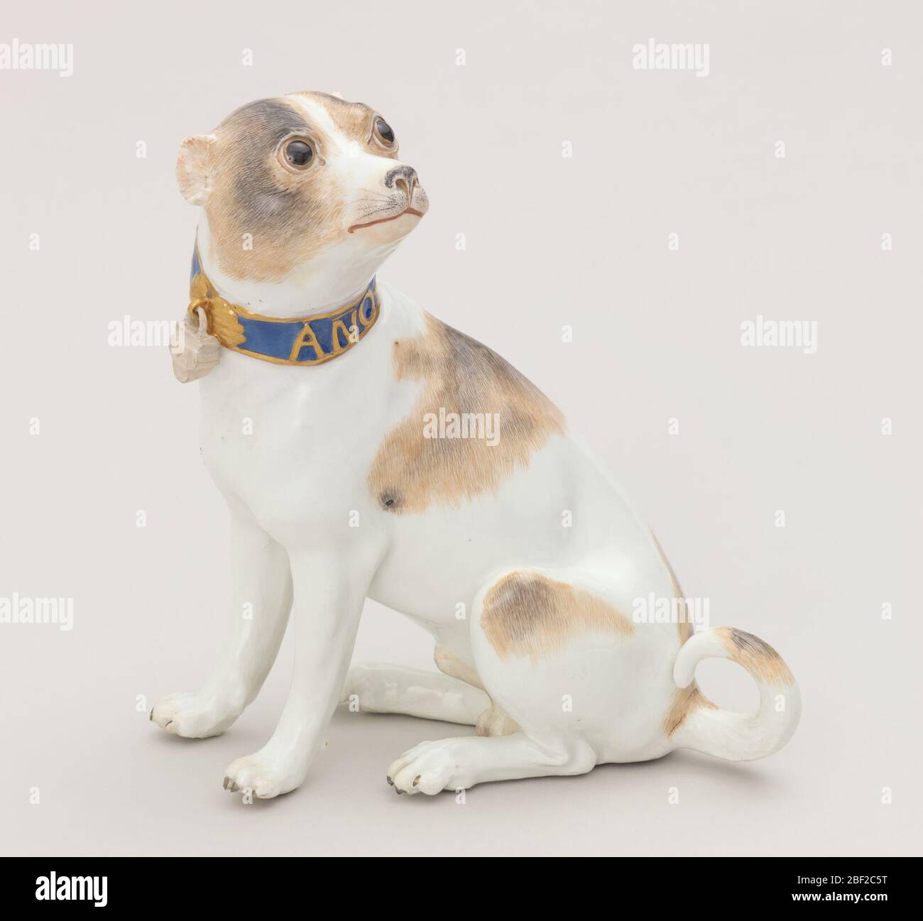 Figure of a Dog. Figure of a brown-spotted pug with cropped ears and a ...