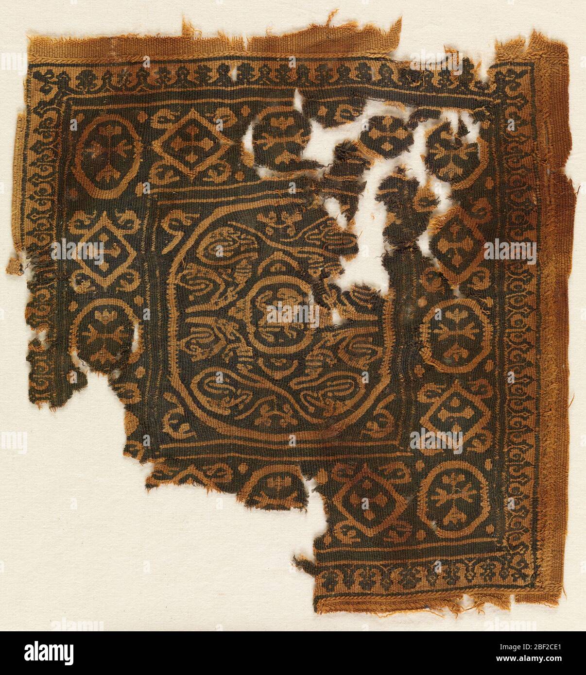 Fragment. Fragment of a square tapestry woven panel of purple wool and ...